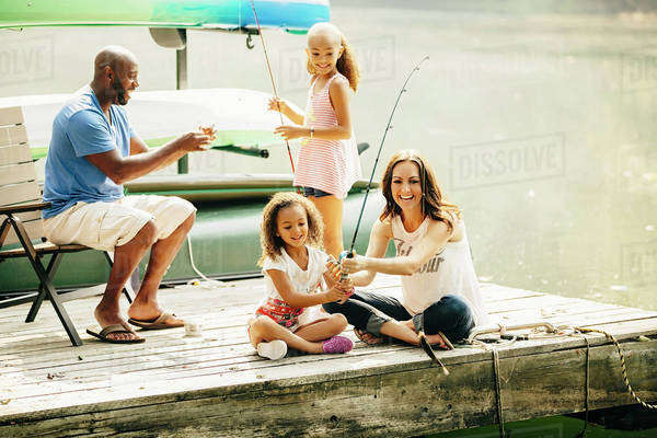 Family fishing in lake - Stock Photo - Dissolve