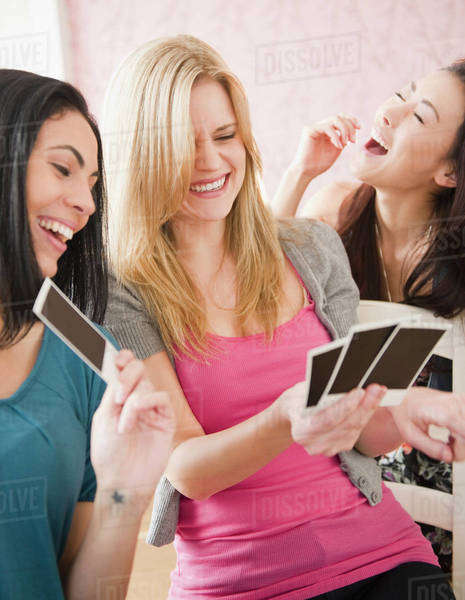 Friends looking at photographs together - Royalty-free Stock Photo ...