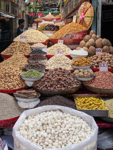 DELHI, INDIA - MARCH 14, 2019: a vendor selling nuts at the spice market of chandni chowk ...