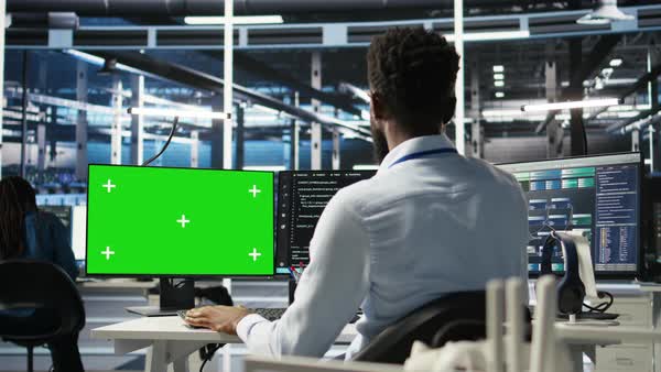 Data center admin using green screen PC to do node tree programming ...