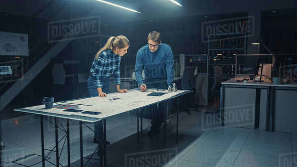 In the Dark Industrial Design Engineering Facility Male and Female Engineers Work on a ...