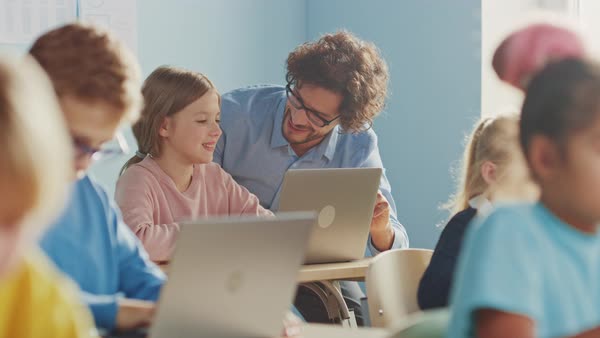 Elementary School Computer Science Class: Smart Girl Uses Laptop ...