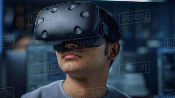 Close-up Portrait of Software Delevoper Wearing Virtual Reality Headset to Develop and Program ...