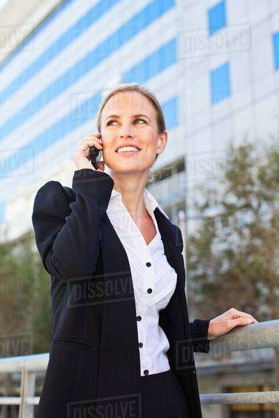 Businesswoman talking on cell phone - Stock Photo - Dissolve