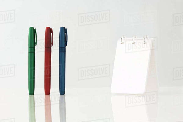Colorful pens upright on table, notebook - Royalty-free Stock Photo ...
