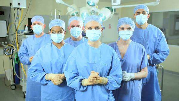 Portrait 6 multi ethnic hospital surgical staff dressed in protective ...