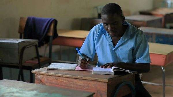 School boy doing homework in an empty classroom in Kenya, Africa ...
