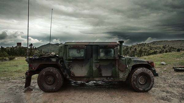Humvee sitting in mud with storm clouds in the sky. Green Beret United ...