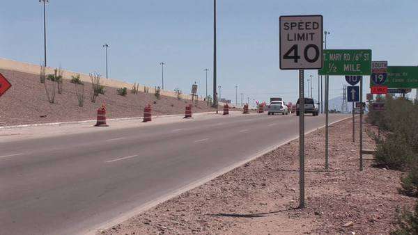 Multiple Traffic Control Signs Along A Freeway On Ramp; Safety Barrels ...