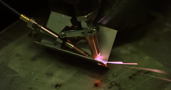 Laser welding machine with hand hold gun. Laser welding is shown in ...