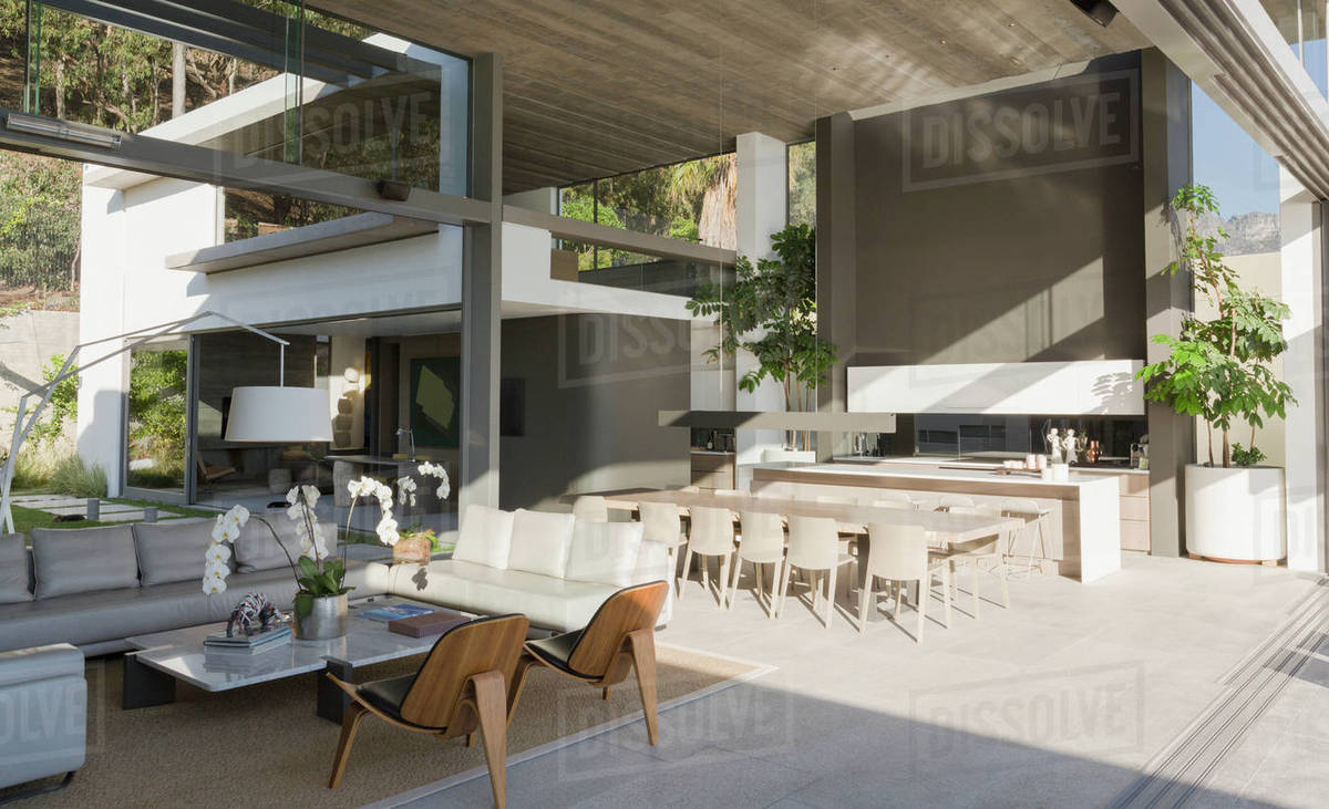 Sunny modern, luxury home showcase interior living room and dining room ...