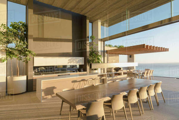 Sunny modern, luxury home showcase interior dining table with ocean ...