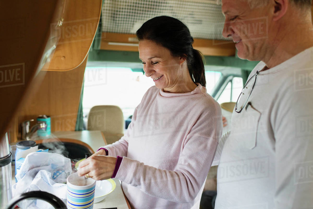 Couple making tea in motor home - Stock Photo - Dissolve