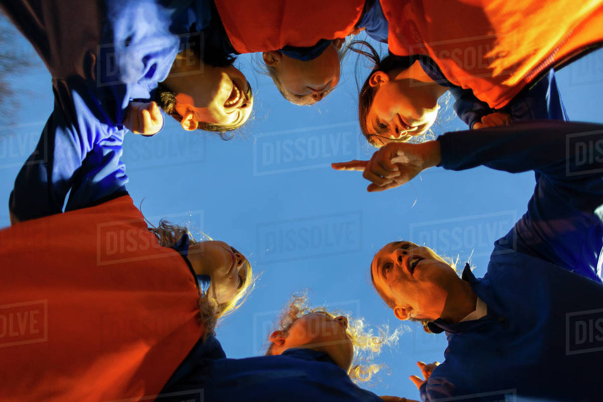 Girls soccer team listening to coach in huddle - Royalty-free Stock ...