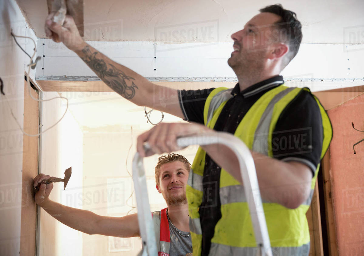 Construction workers plastering - Royalty-free Stock Photo | Dissolve