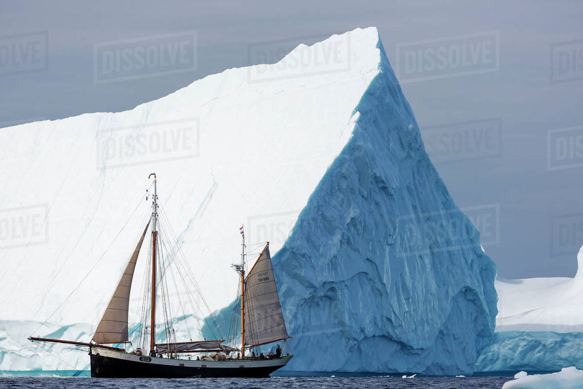 Ship sailing below majestic iceberg Atlantic Ocean Greenland - Stock ...