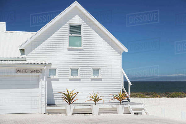 White beach house with sunny ocean view - Royalty-free Stock Photo ...