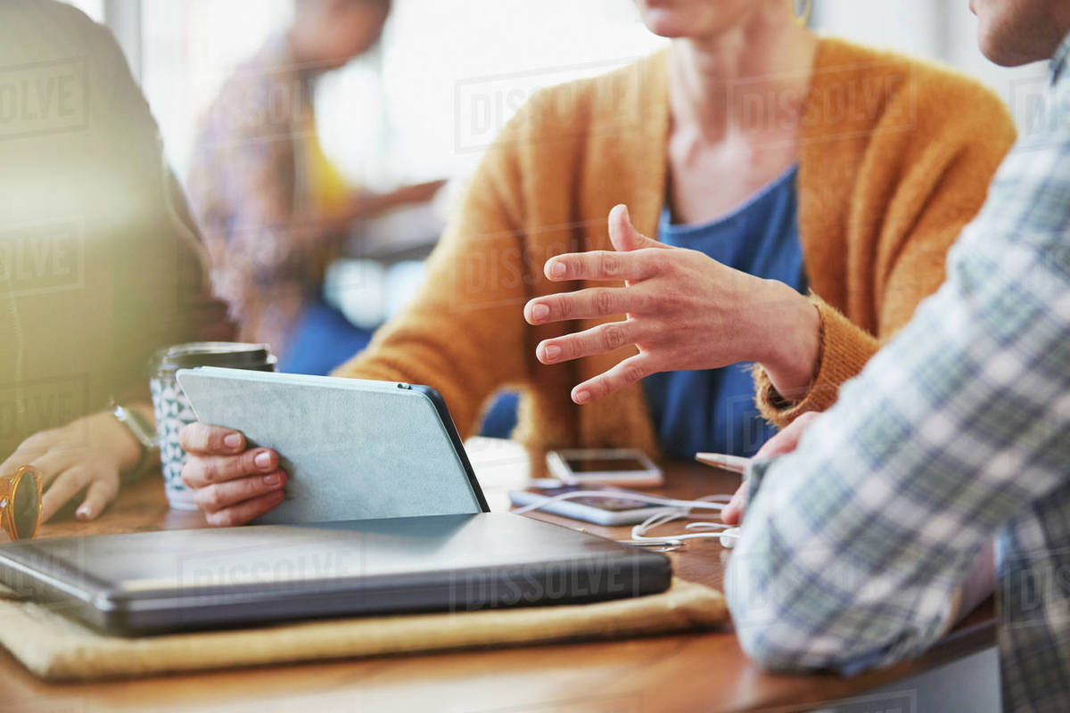 Business people with digital tablet meeting at cafe table - Royalty ...