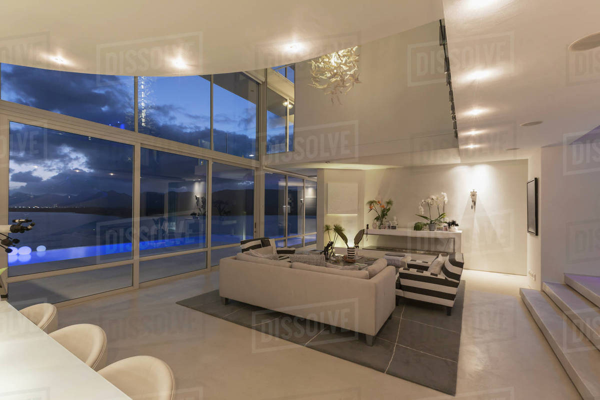 Illuminated modern luxury home showcase interior at night - Royalty ...