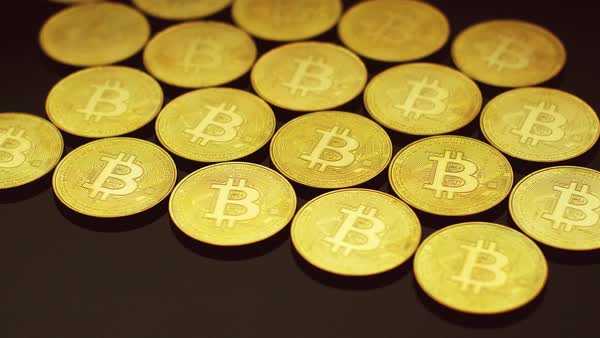 Arranged golden coins with symbol of bitcoin currency lying together in ...