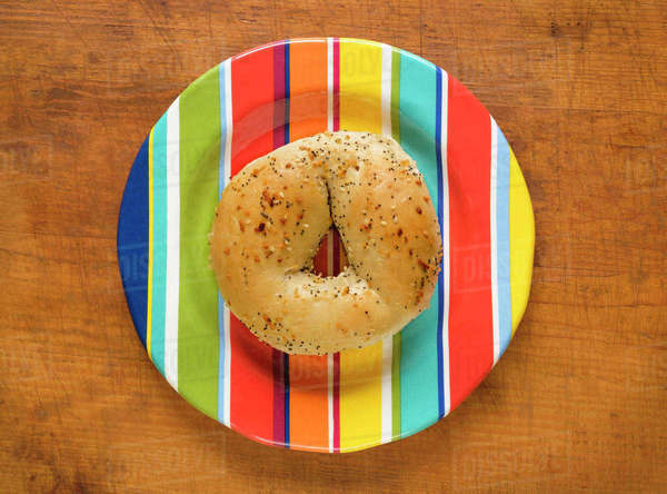 Bagel on colorful plate - Stock Photo - Dissolve