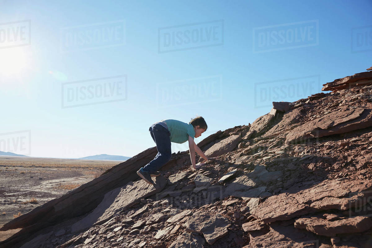 USA, Arizona, Boy moving up on rock - Royalty-free Stock Photo | Dissolve