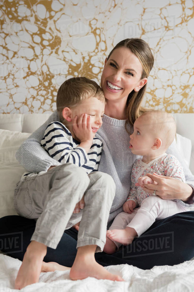 Portrait of happy mother of two children (18-23 months, 4-5) - Stock ...