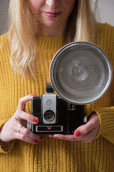 Woman holding old camera - Stock Photo - Dissolve