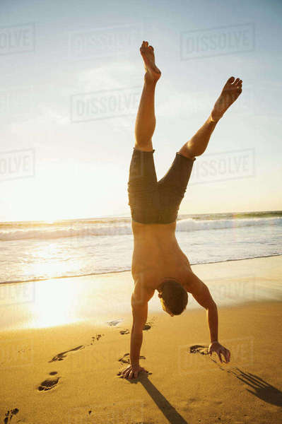 Man standing on hand - Stock Photo - Dissolve