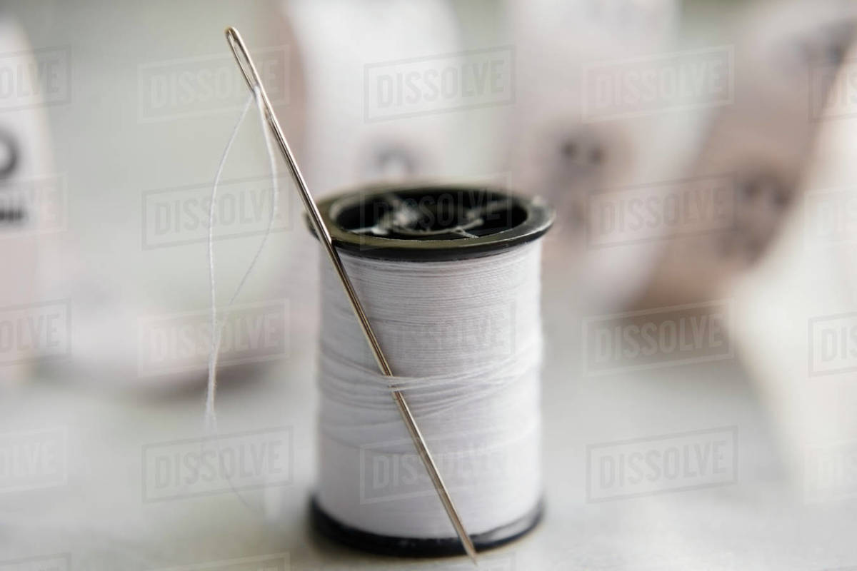 White thread and needle - Royalty-free Stock Photo | Dissolve