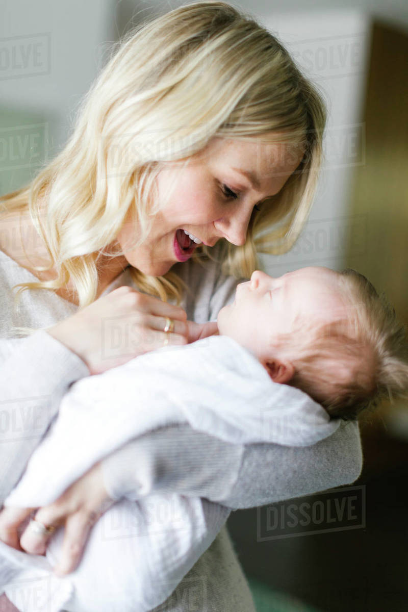 Woman holding her baby son - Stock Photo - Dissolve