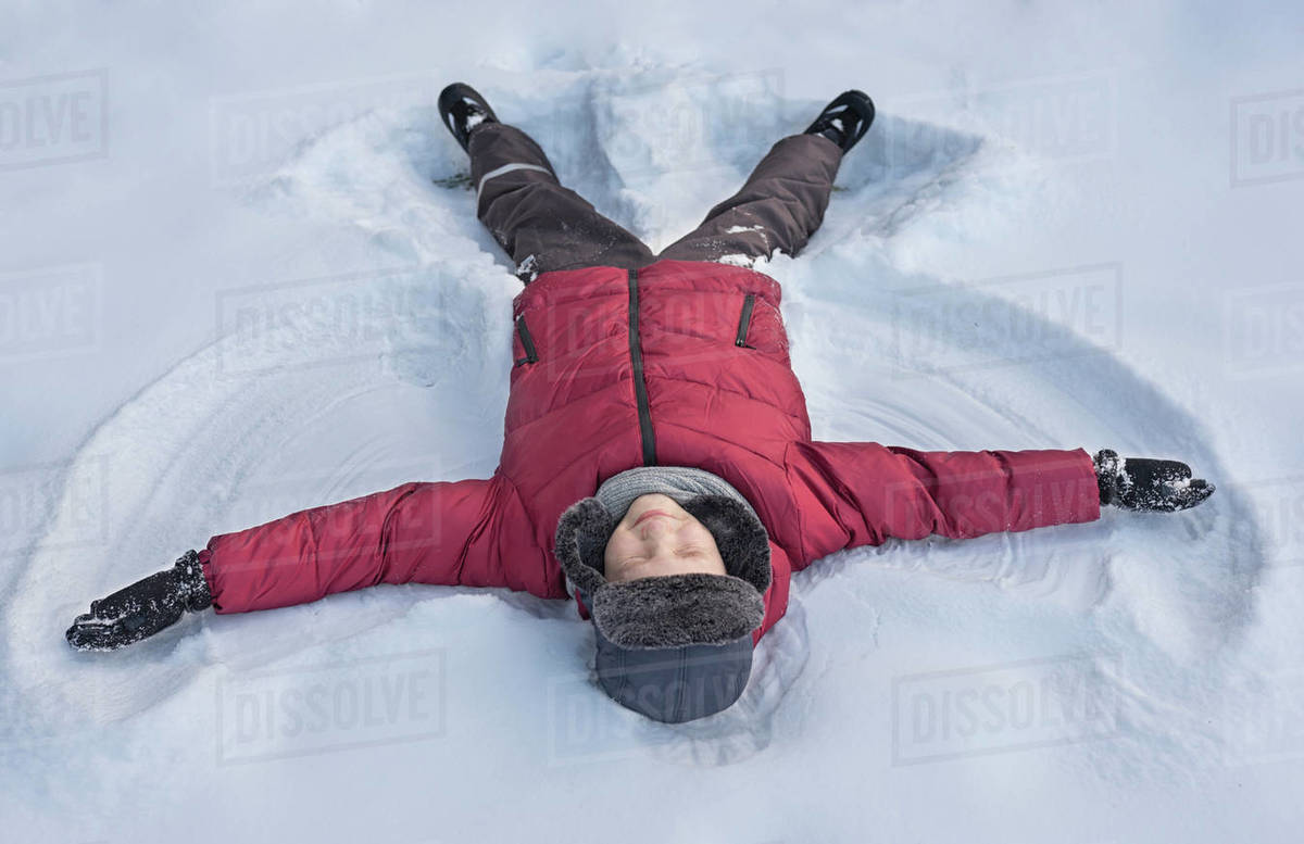 Boy making snow angel - Royalty-free Stock Photo | Dissolve