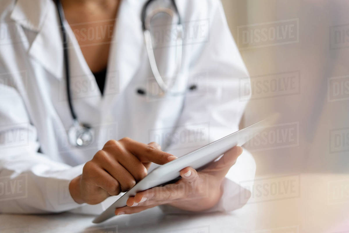 Doctor using digital tablet - Royalty-free Stock Photo | Dissolve