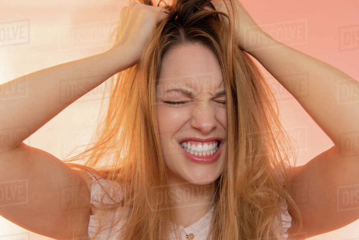 Stressed young woman with her hands in her hair - Royalty-free Stock ...