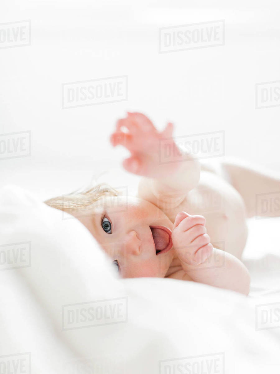 Baby girl lying on her side - Royalty-free Stock Photo | Dissolve