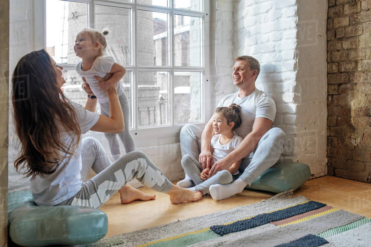 Family sitting by window - Stock Photo - Dissolve