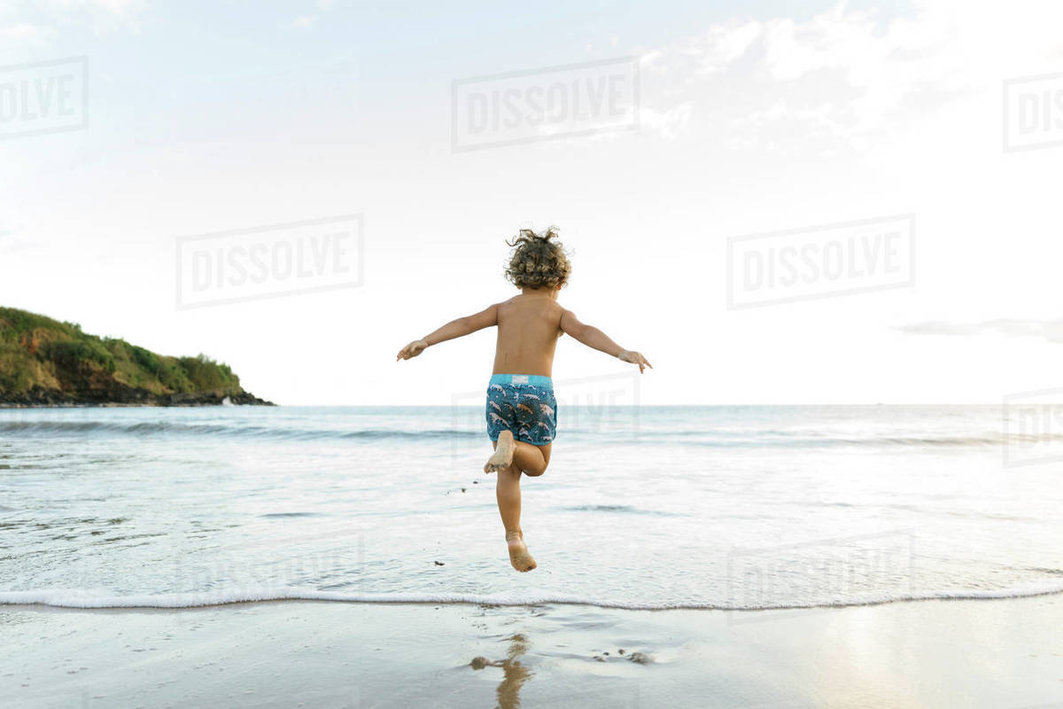 Boy playing on beach - Stock Photo - Dissolve