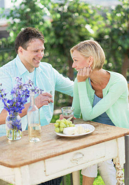 Couple sitting at table outdoors - Royalty-free Stock Photo | Dissolve