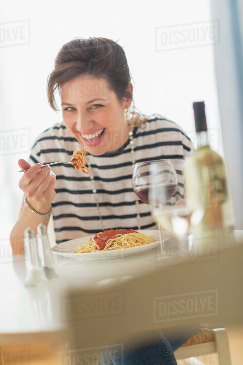Woman eating spaghetti - Royalty-free Stock Photo | Dissolve