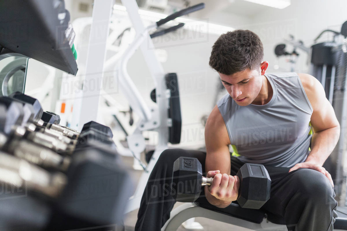 Young man working out at gym - Royalty-free Stock Photo | Dissolve