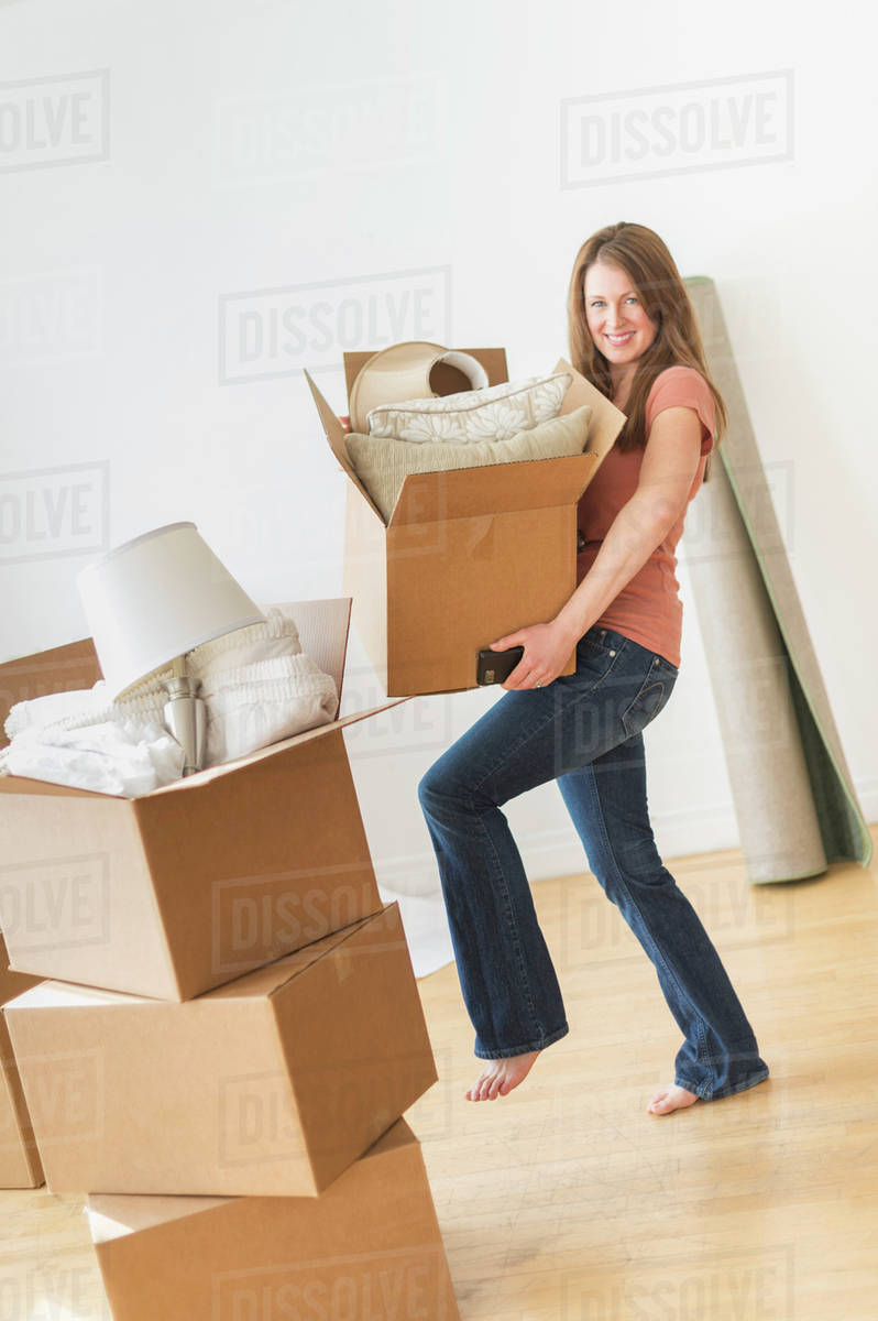 Portrait of woman moving in to new house - Royalty-free Stock Photo ...