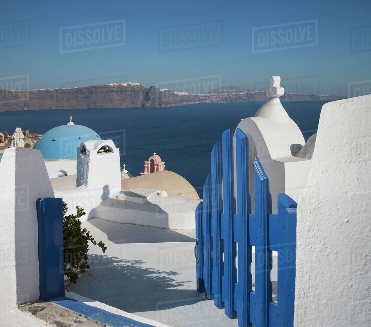 Open blue gate by whitewashed church in Santorini, Greece - Royalty ...
