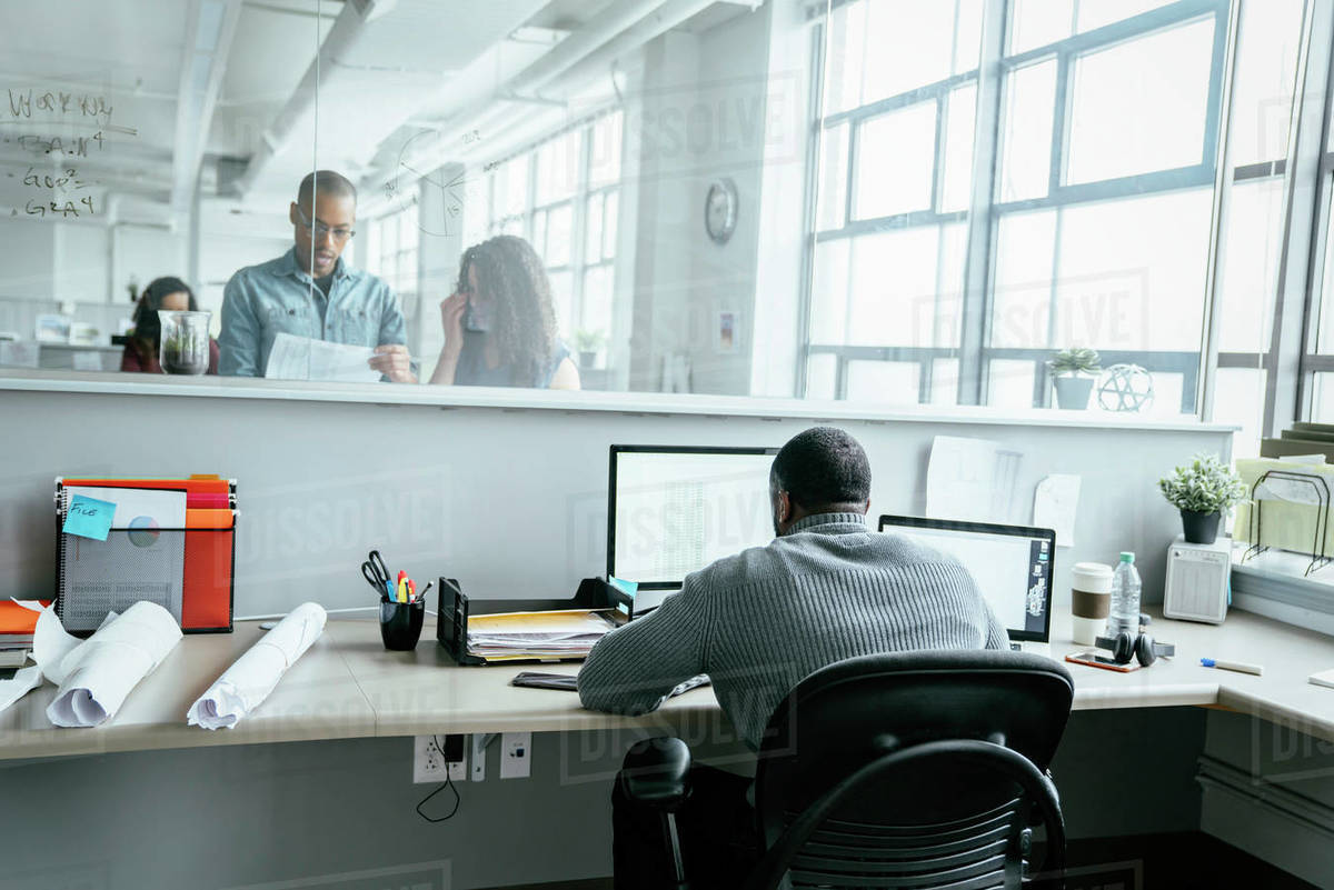 Man using computer in office - Stock Photo - Dissolve