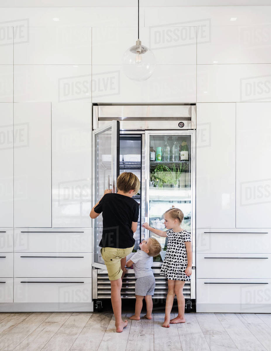 Children opening refrigerator - Royalty-free Stock Photo | Dissolve