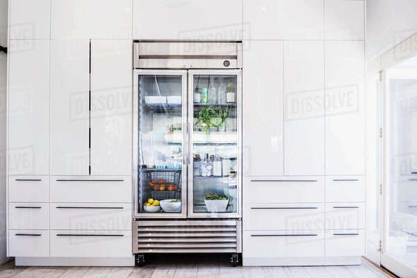 Glass refrigerator in modern kitchen - Royalty-free Stock Photo | Dissolve