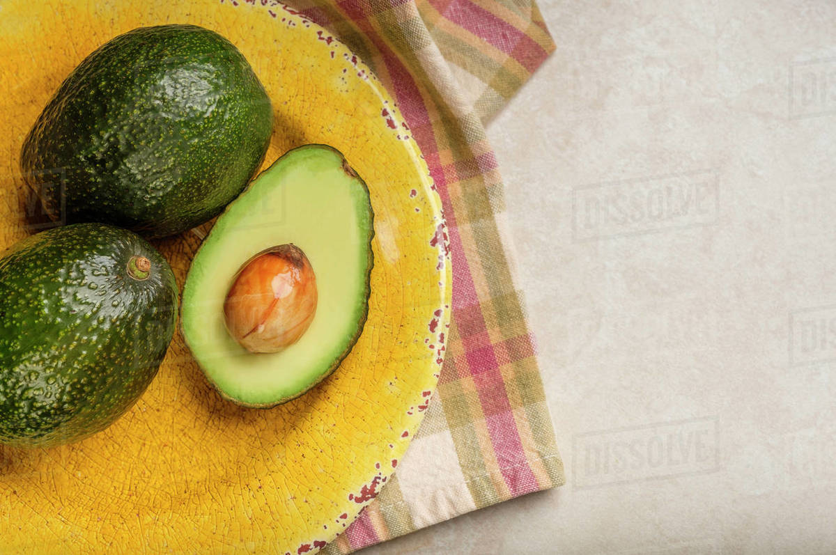 Avocados on plate - Stock Photo - Dissolve