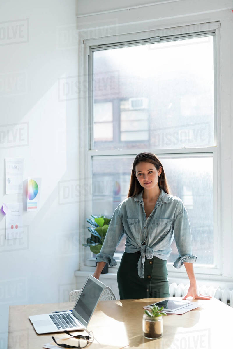 Business woman standing behind office desk - Royalty-free Stock Photo ...