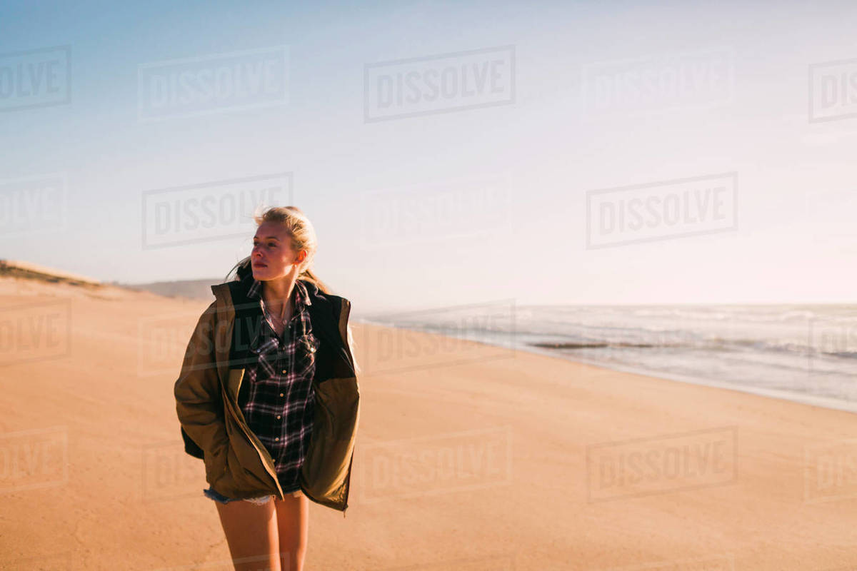 Woman wearing jacket at beach - Royalty-free Stock Photo | Dissolve