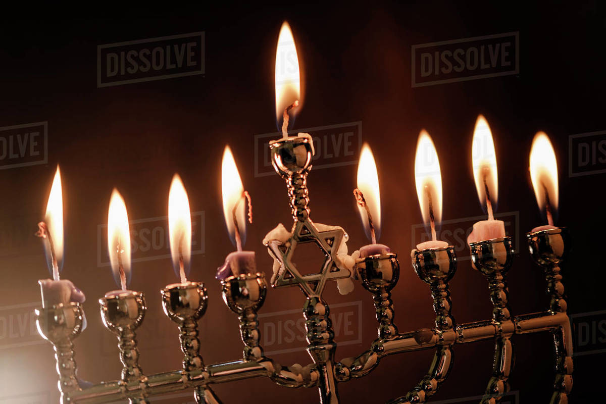 Lit candles in menorah - Royalty-free Stock Photo | Dissolve