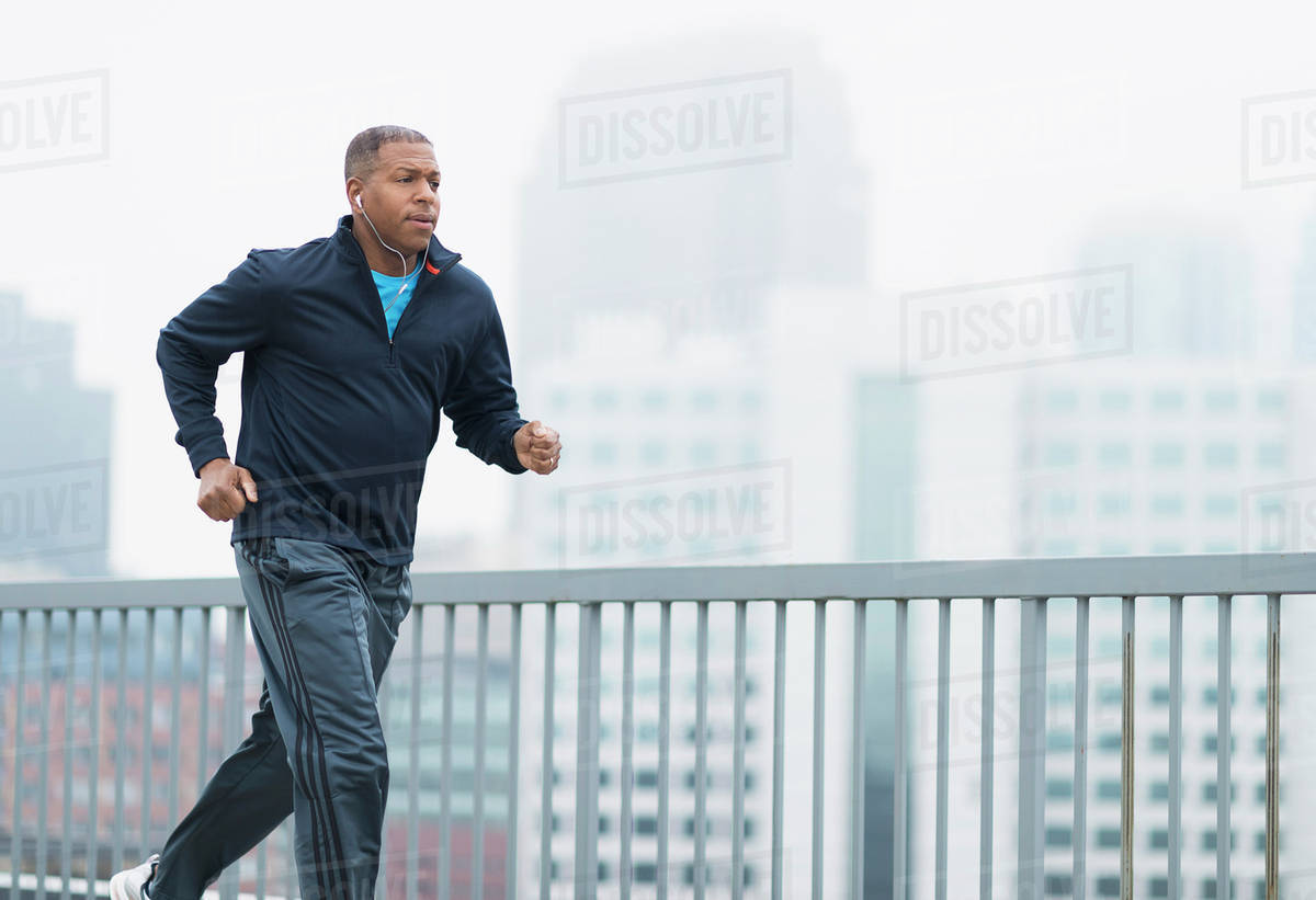 Man running in city - Stock Photo - Dissolve